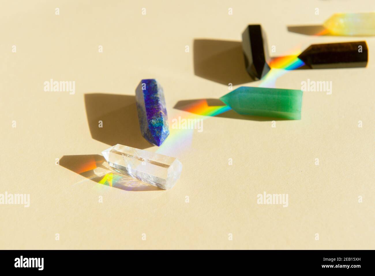 Healing chakra crystals and rainbow on beige background. Meditation ...