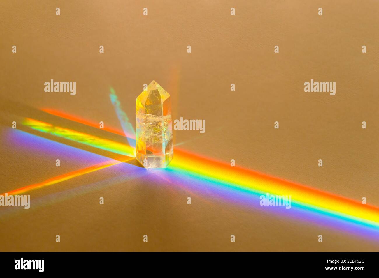 Healing chakra crystal and rainbow on beige background. Meditation ...