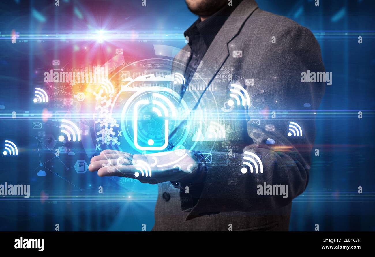 Businessman holding wifi signal icon in his hands with multiple ...