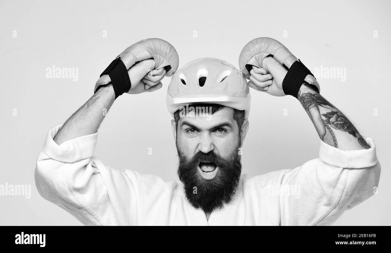 Man with beard in kimono and pink helmet on white background. Karate ...