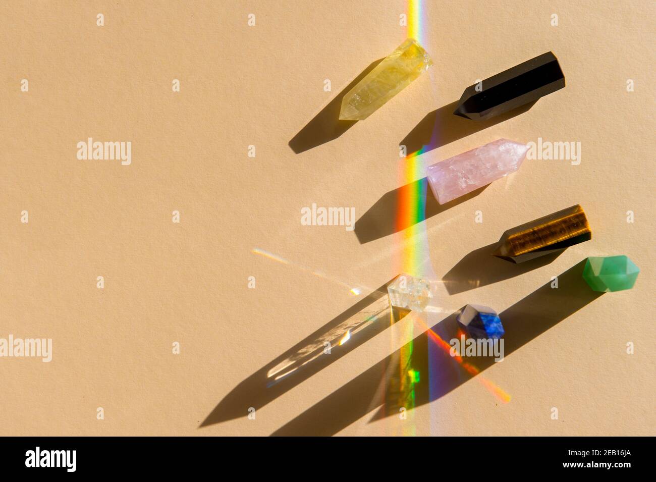 Healing chakra crystals and rainbow on beige background. Meditation ...