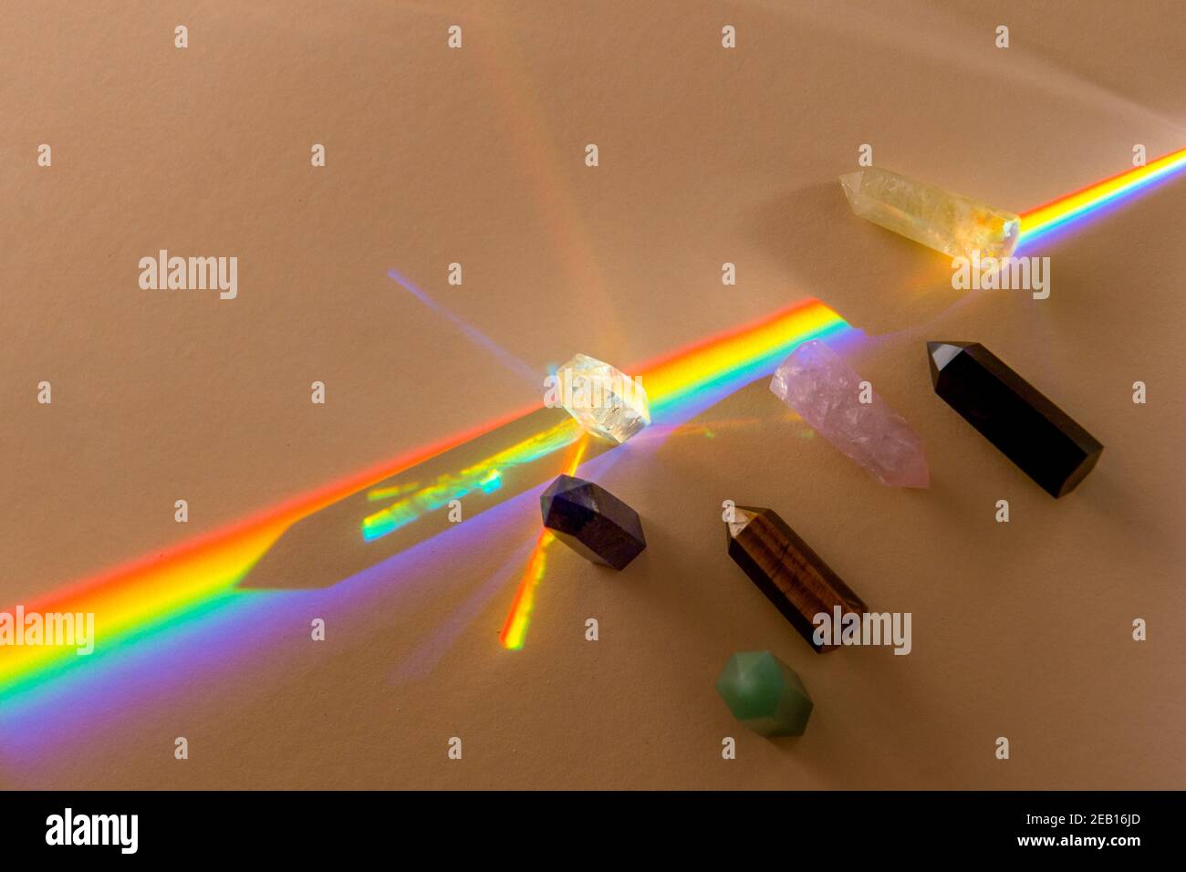 Healing chakra crystals and rainbow on beige background. Meditation ...