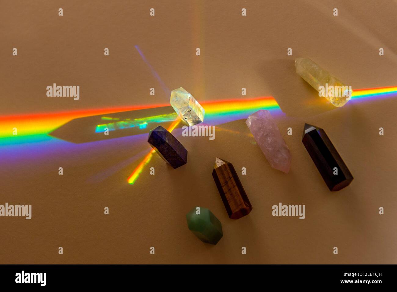 Healing chakra crystals and rainbow on beige background. Meditation ...