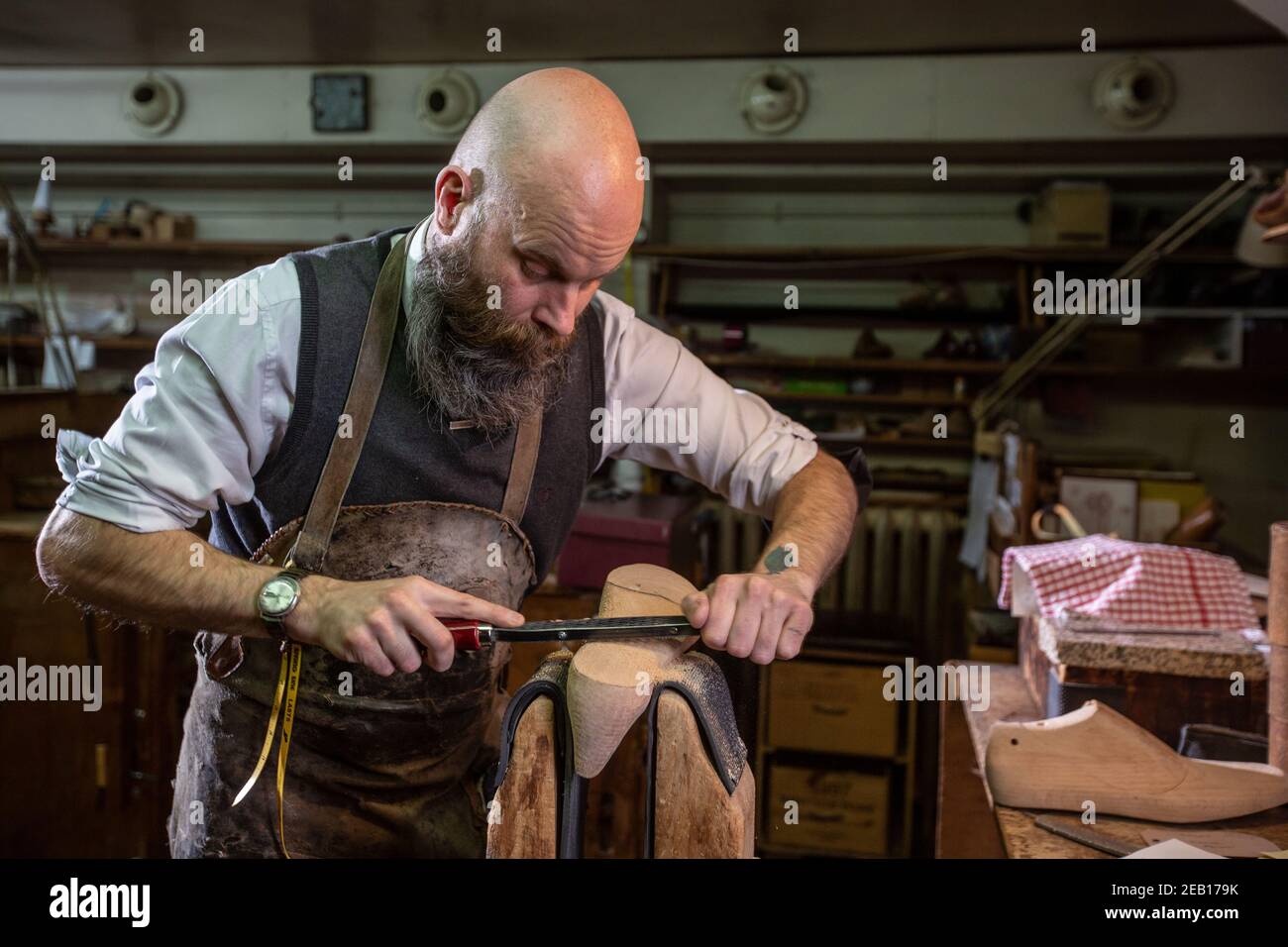 Fitter and Last Maker works at his bench inside John Lobb, makers of ...