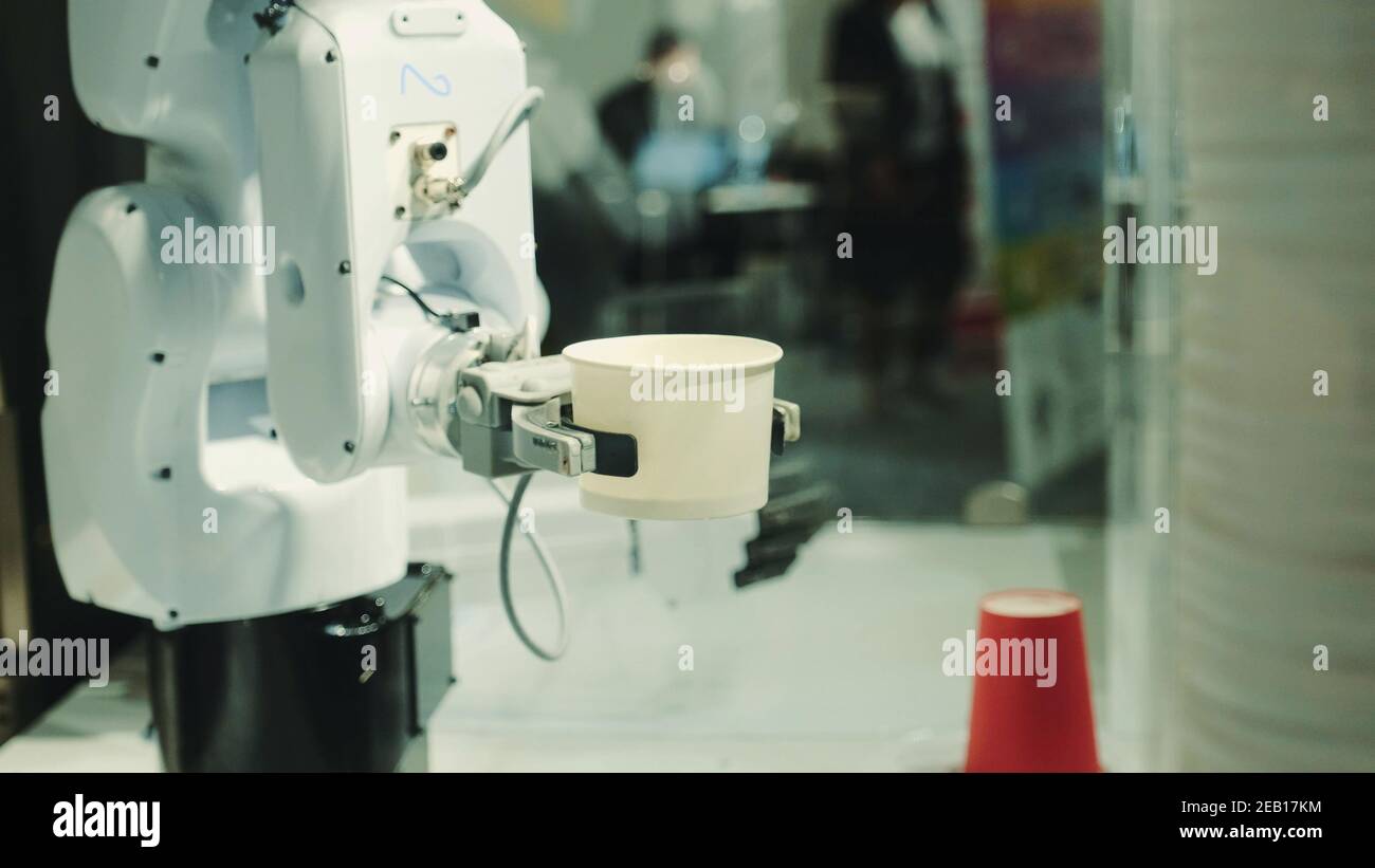 Robot with artificial intelligence making coffee on coffee machine ...