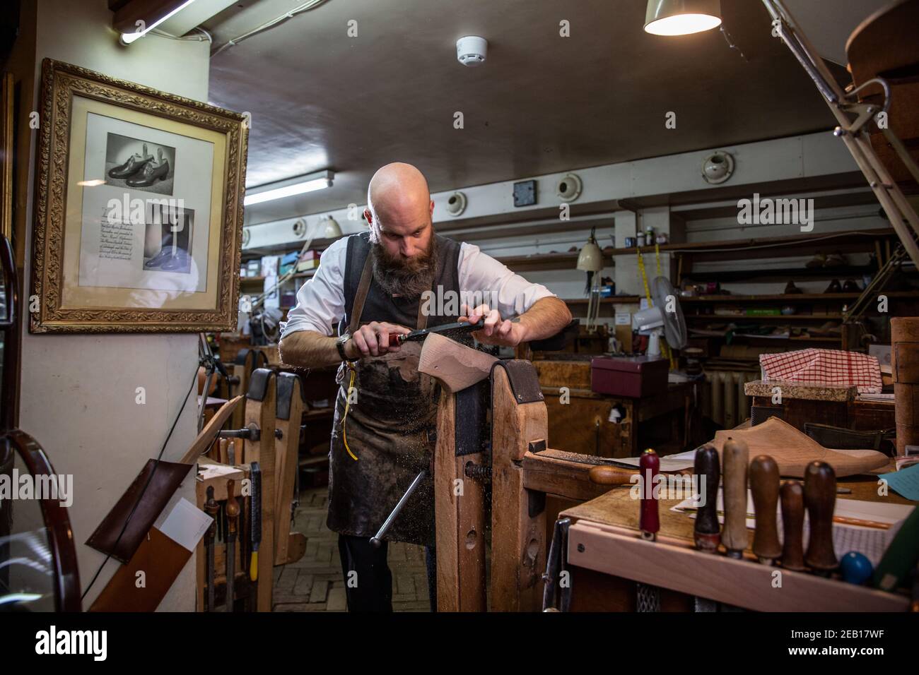 Fitter and Last Maker works at his bench inside John Lobb, makers of ...