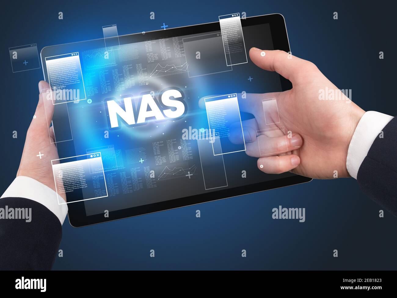 Close-up of a hand holding tablet with NAS abbreviation, modern ...