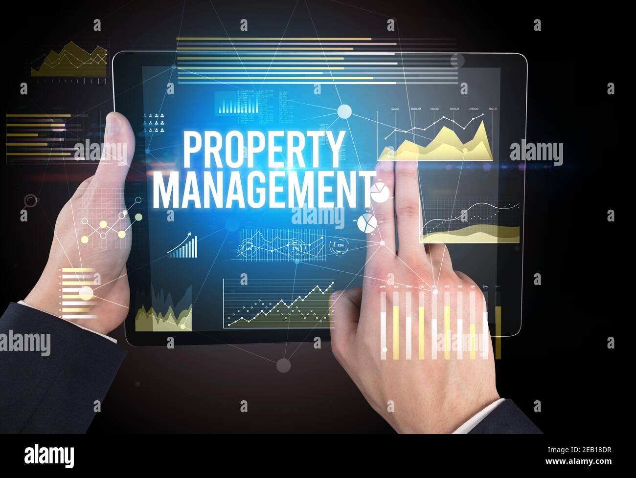 Close-up of hands holding tablet with PROPERTY MANAGEMENT inscription ...