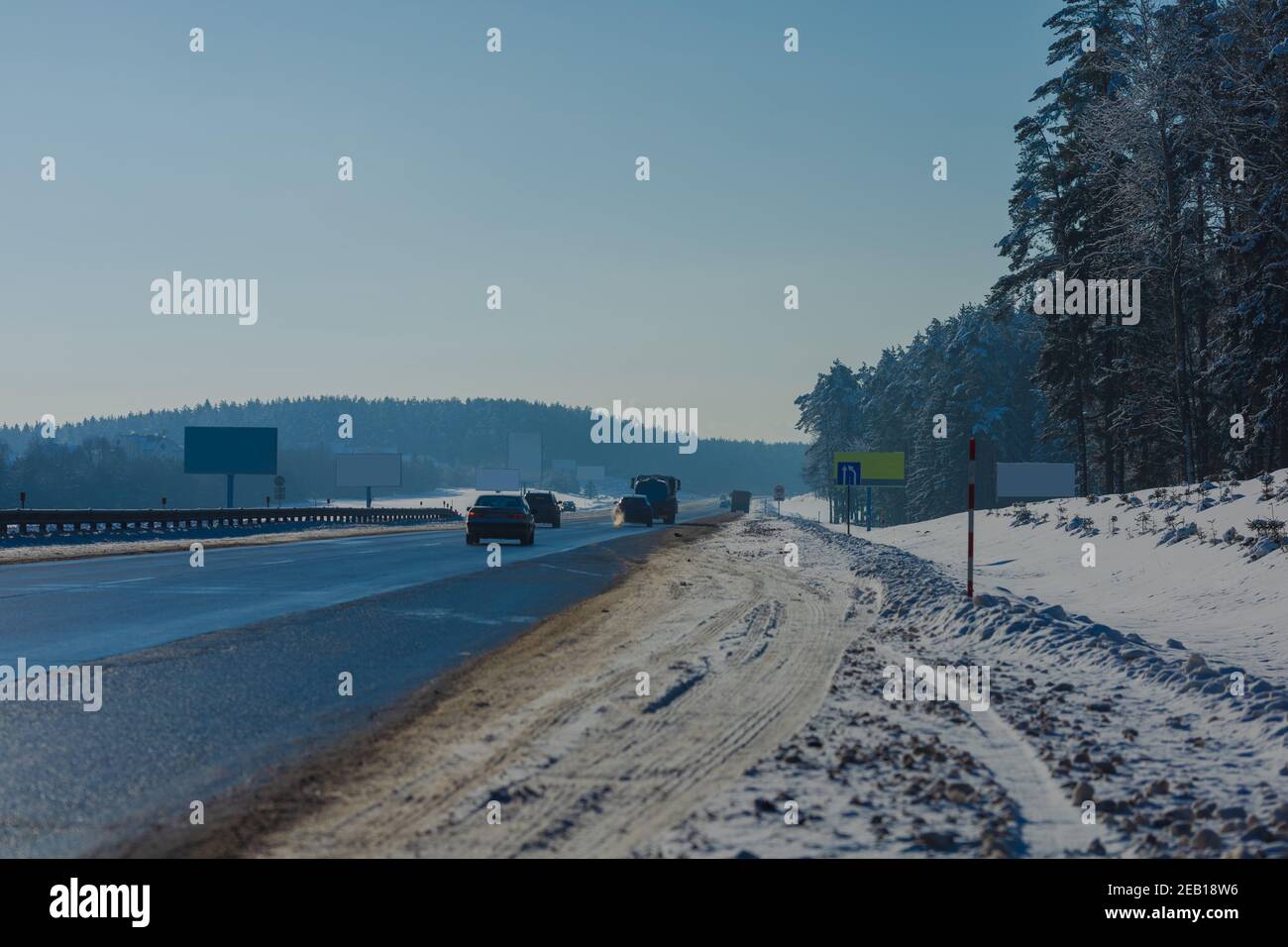 Winter road with snow, highway with cars at sunset Stock Photo - Alamy
