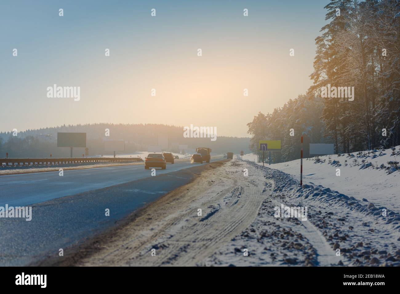 Winter road with snow, highway with cars at sunset Stock Photo - Alamy