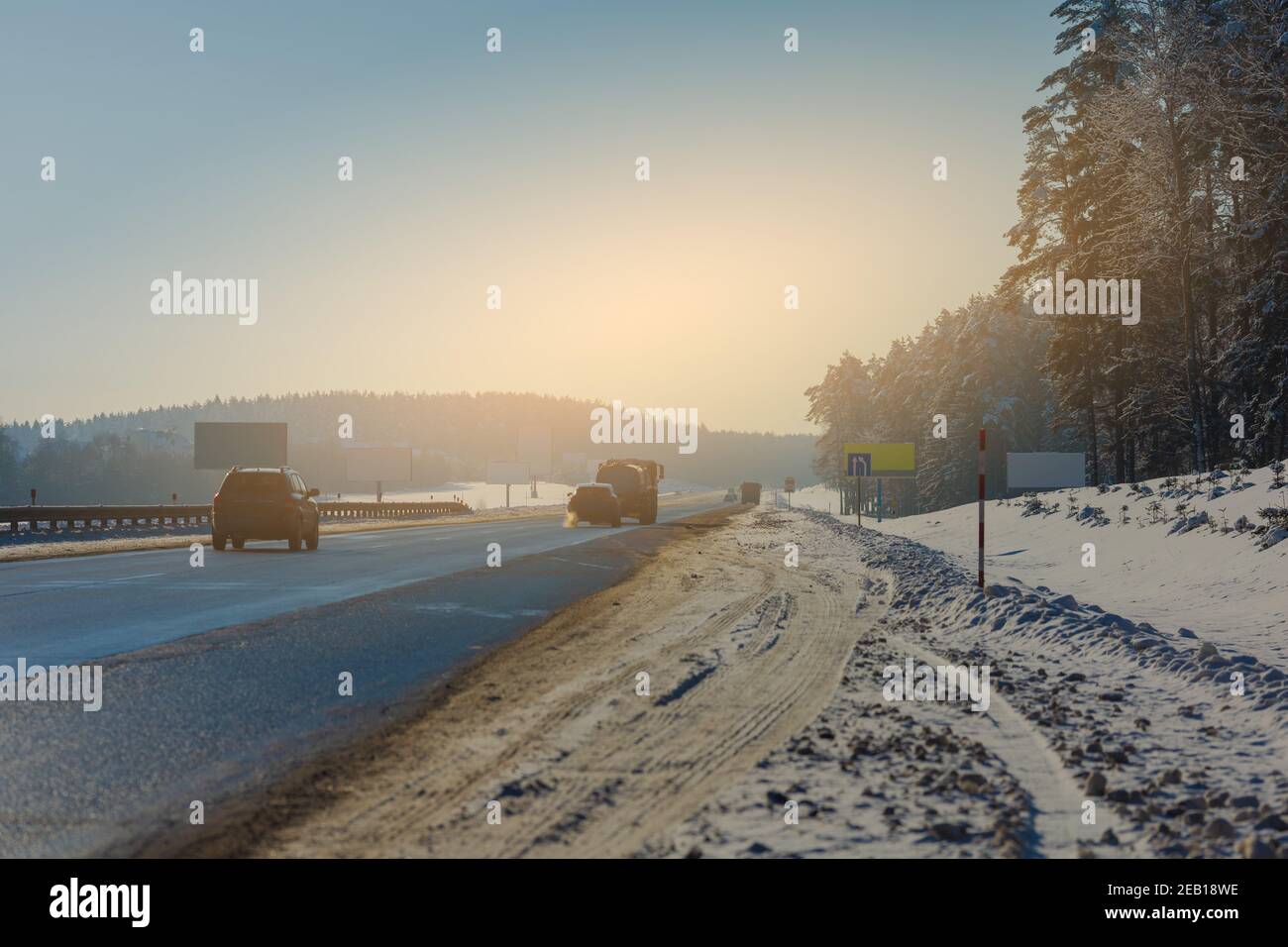 Winter road with snow, highway with cars at sunset Stock Photo - Alamy