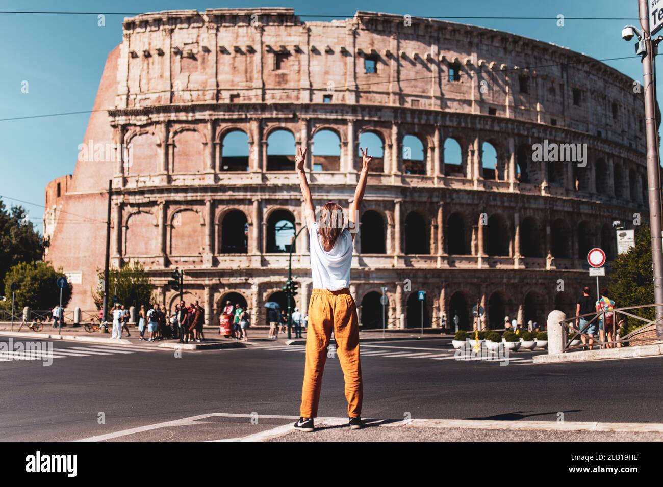 Happy woman in front of the Roman Coliseum Stock Photo - Alamy