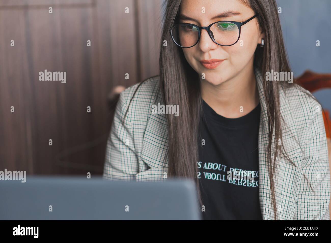 Young woman with her laptop. Performing various tasks and meetings ...