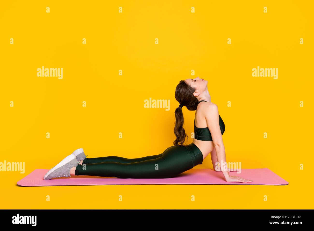 Profile side full body view of attractive slender bendy girl instructor ...