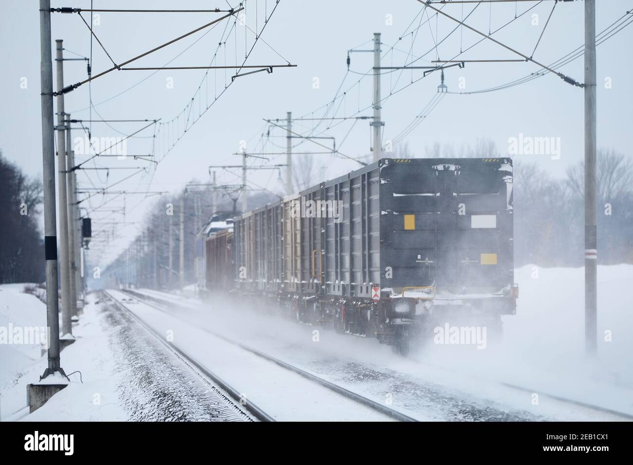 Frosty winter day on railway. Freight train on snowy railroad track ...