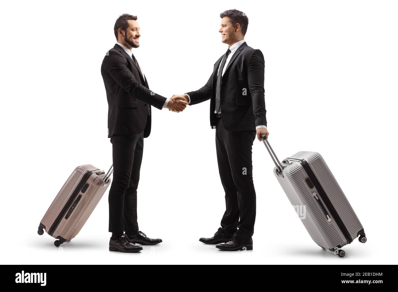 Two young businessmen with suitcases shaking hands isolated on white ...