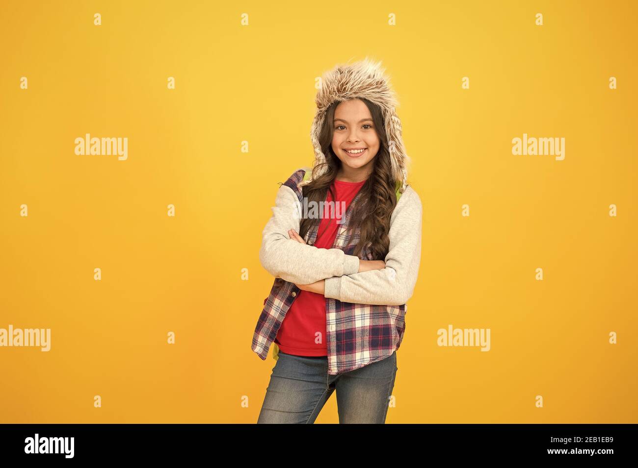 Keep out cold in winter. Small girl smile in faux fur hat yellow ...