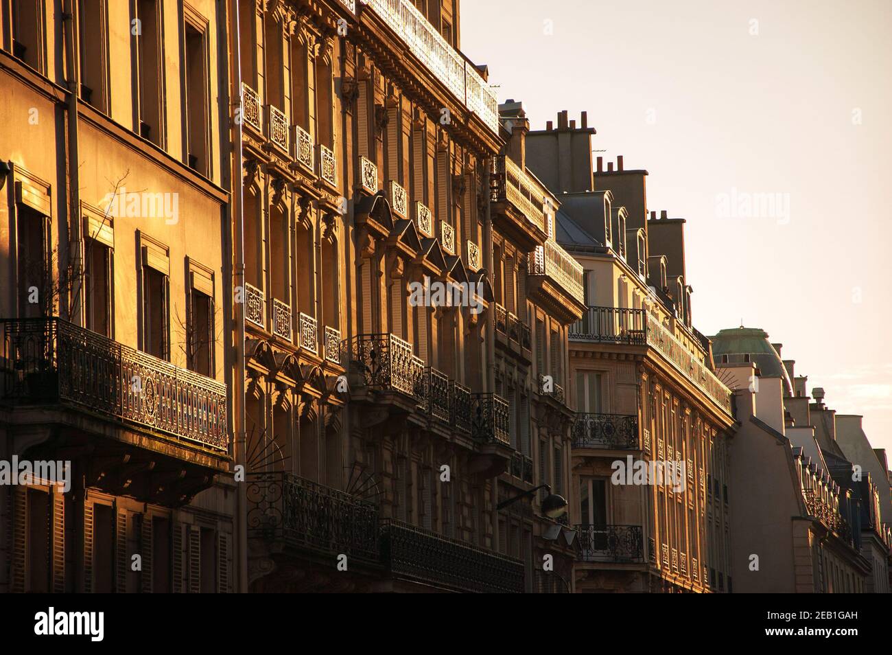 Parisian street buildings in golden sunset light. Typical Parisian ...