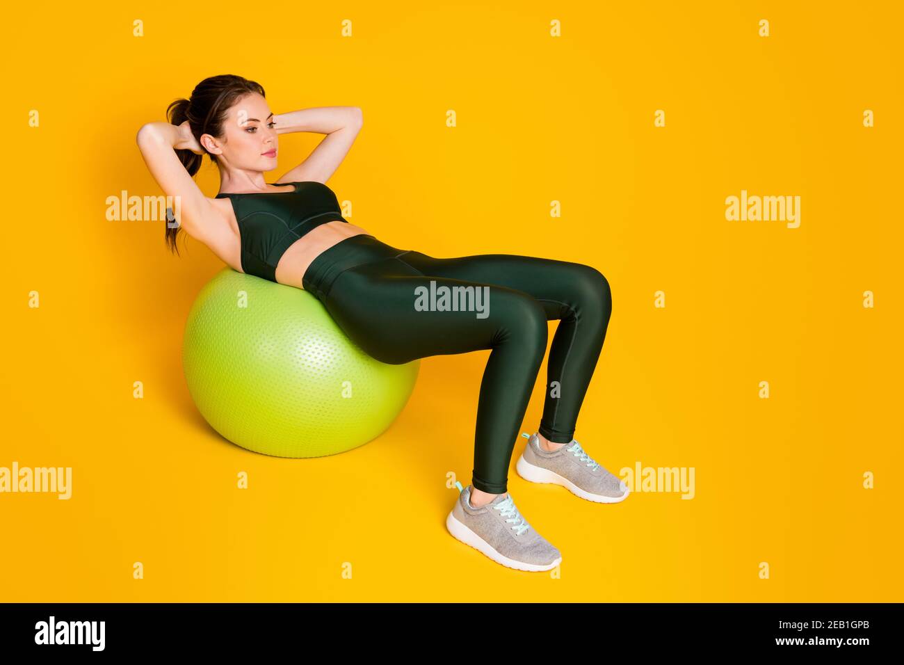 Photo of sportive lady lean big fit ball doing abs sit ups wear sports ...
