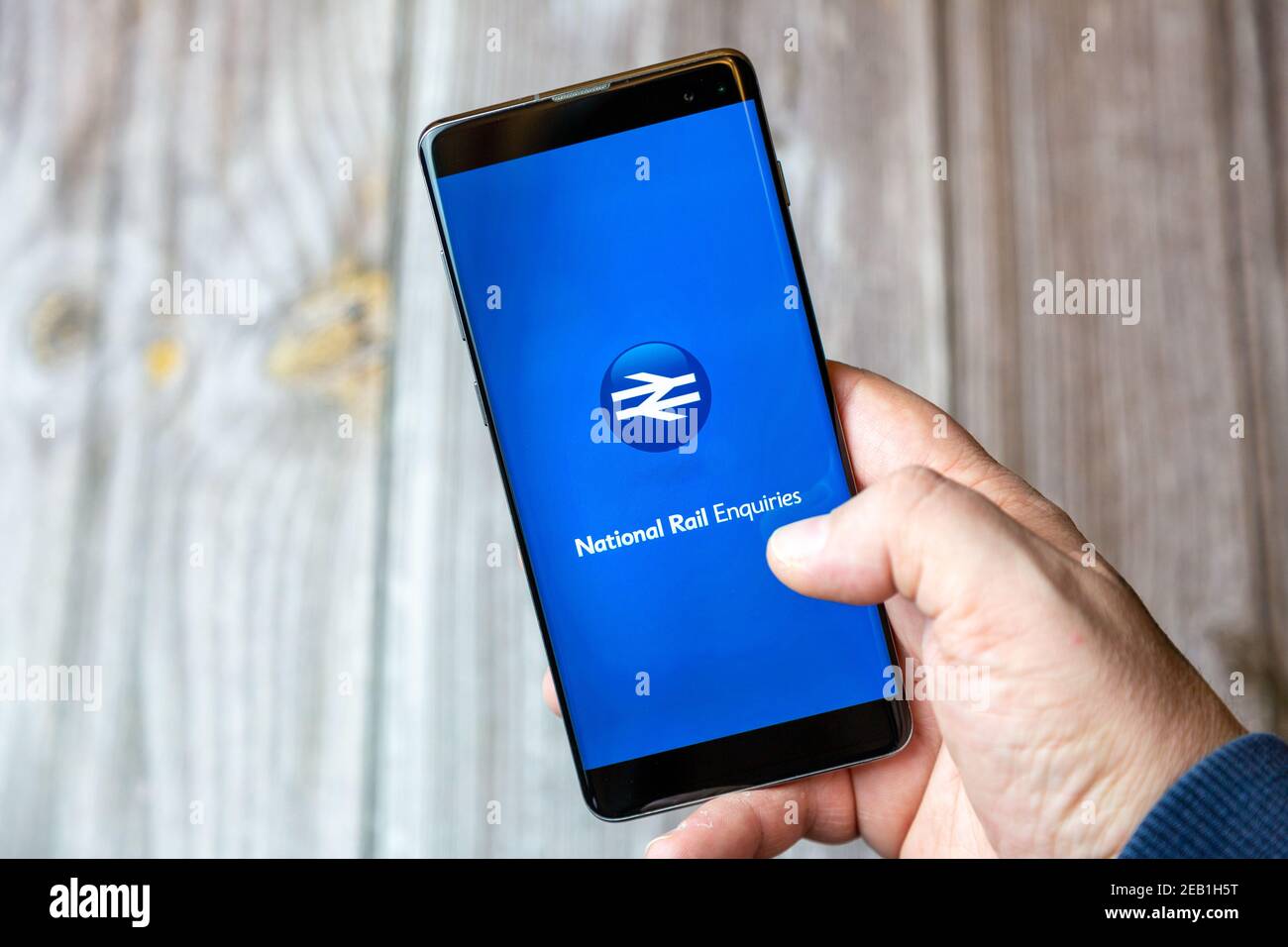 A mobile phone or cell phone being held by a hand with the National ...