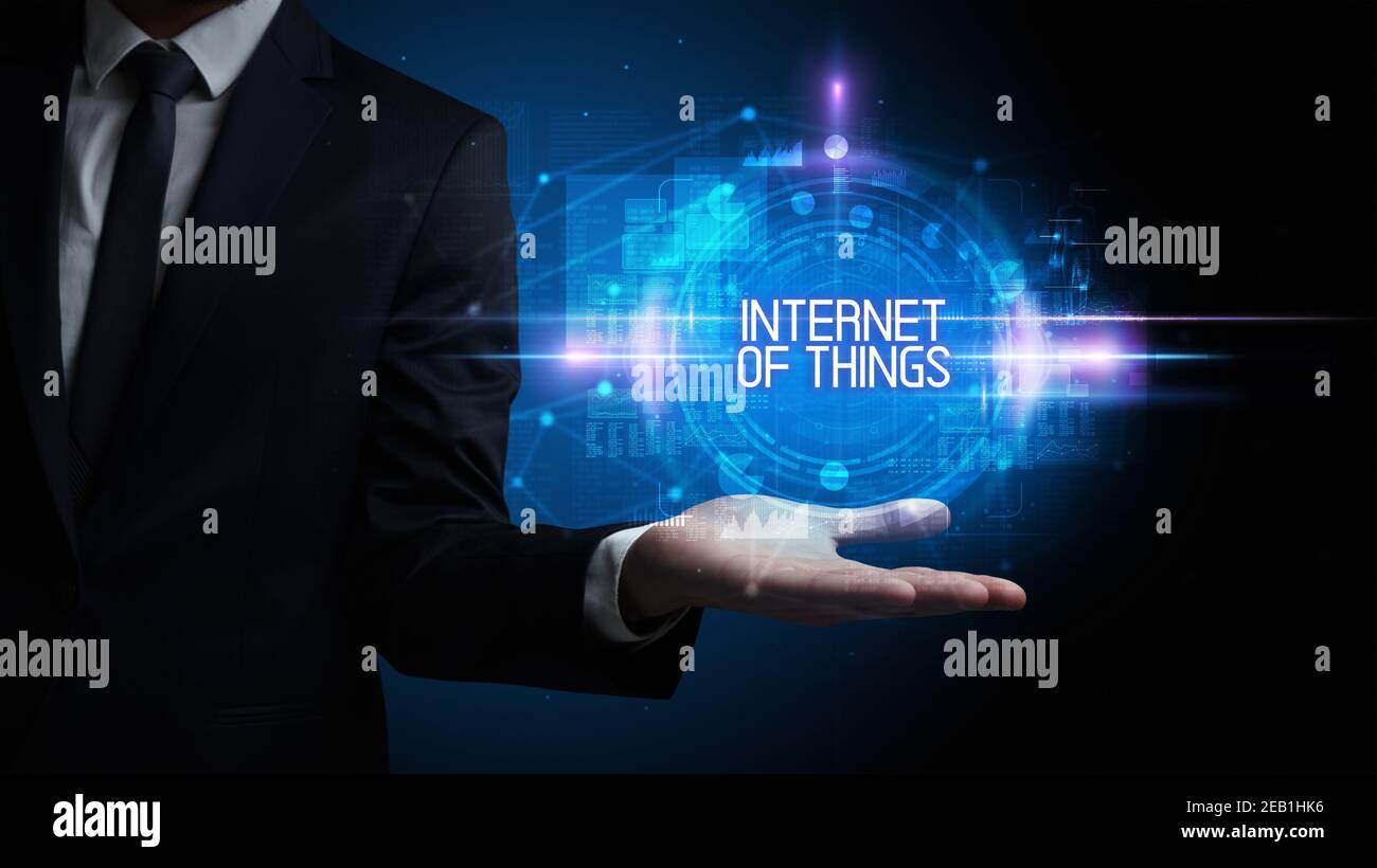 Man hand holding INTERNET OF THINGS inscription, technology concept ...