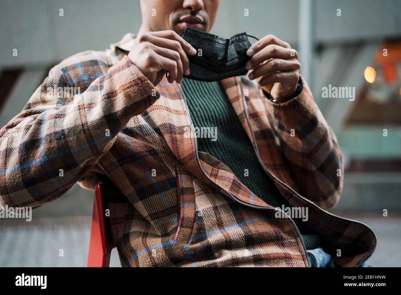 Young handsome man walking on a street wearing a face mask to protect ...