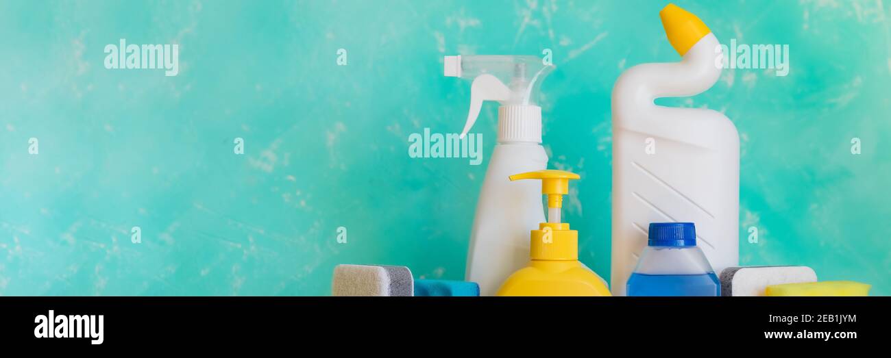 Variety of colorful house cleaning products on blue background.Bottles ...