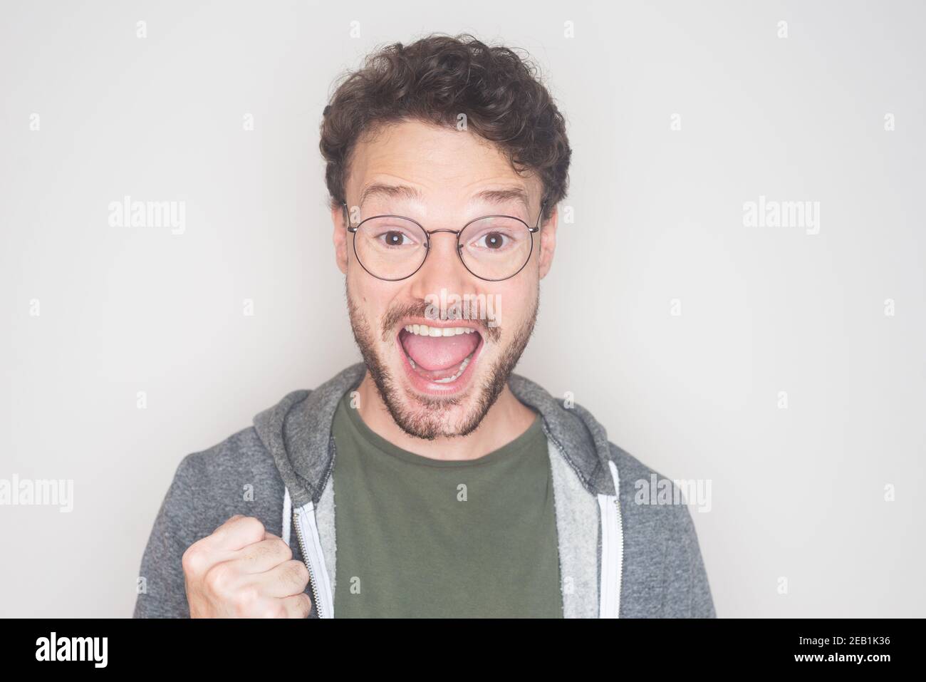 Guy with Glasses Happy Cheering Stock Photo - Alamy
