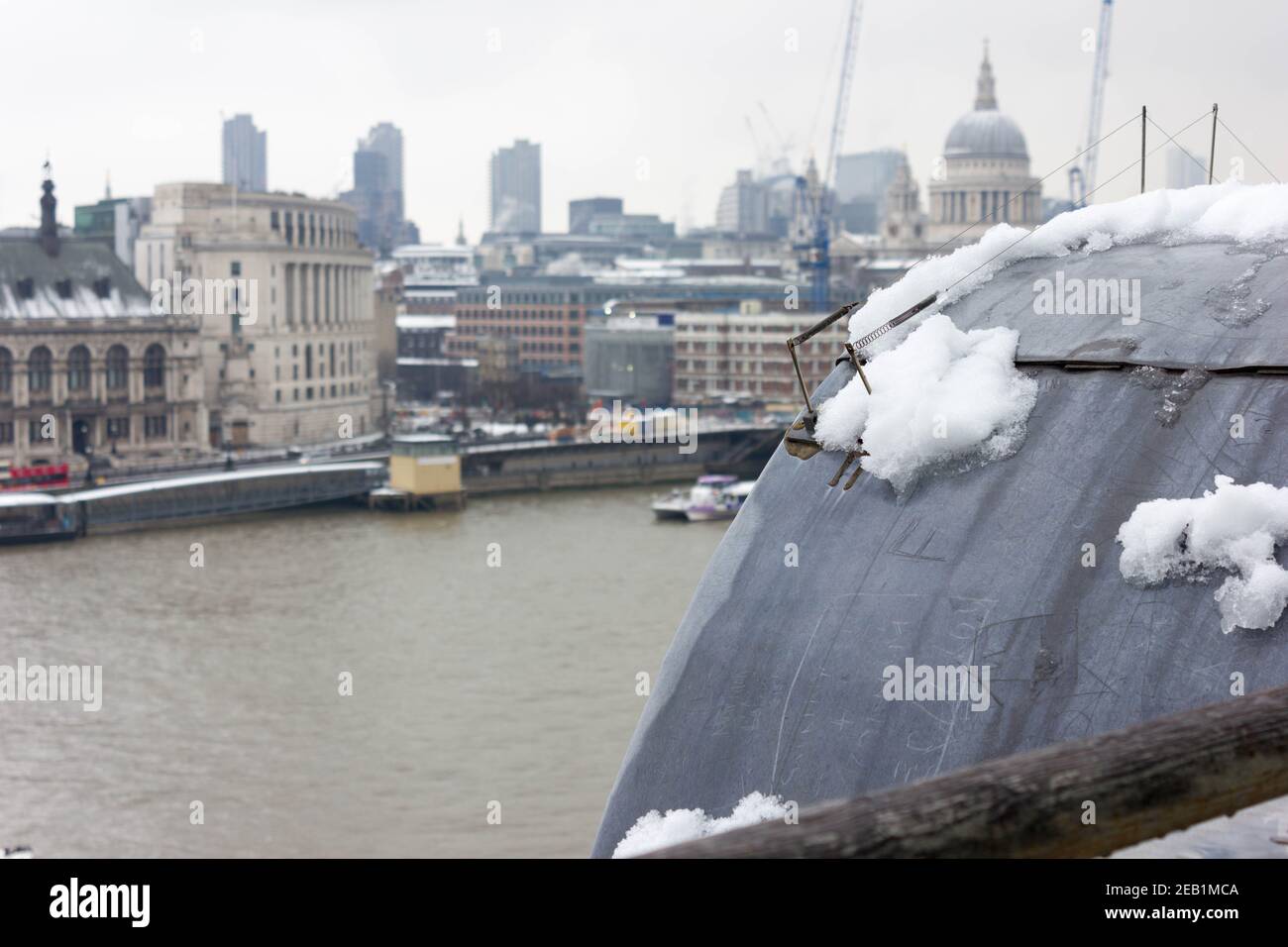 snow on top of window sill overlooking city of London, st Pauls ...
