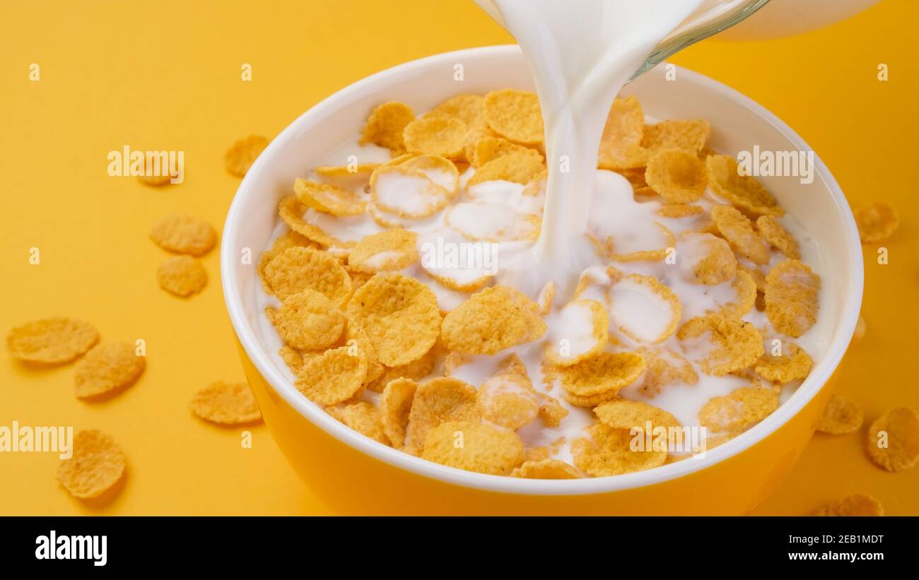 Milk pouring into bowl of corn flakes Stock Photo - Alamy