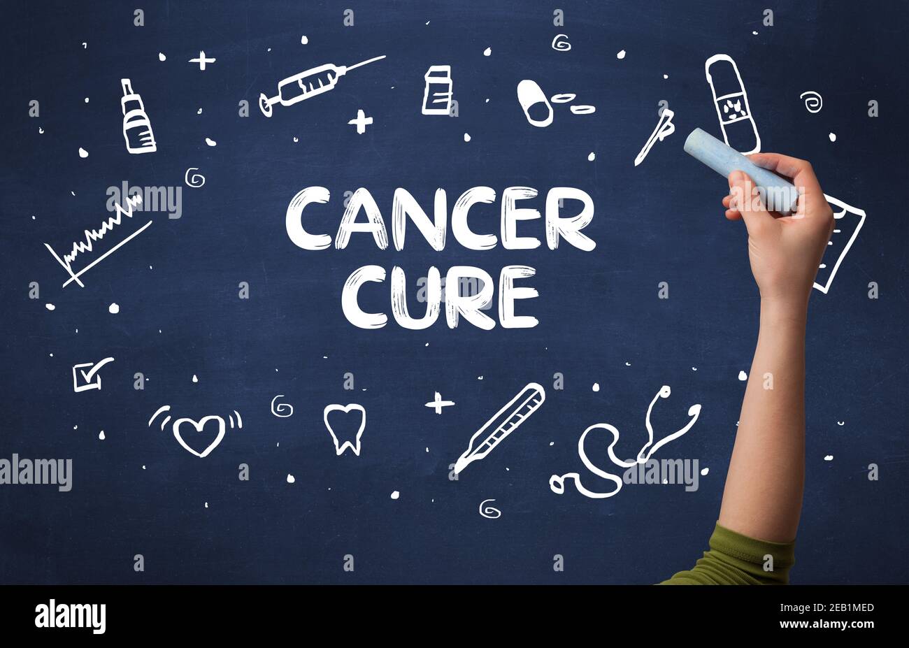 Hand drawing CANCER CURE inscription with white chalk on blackboard ...