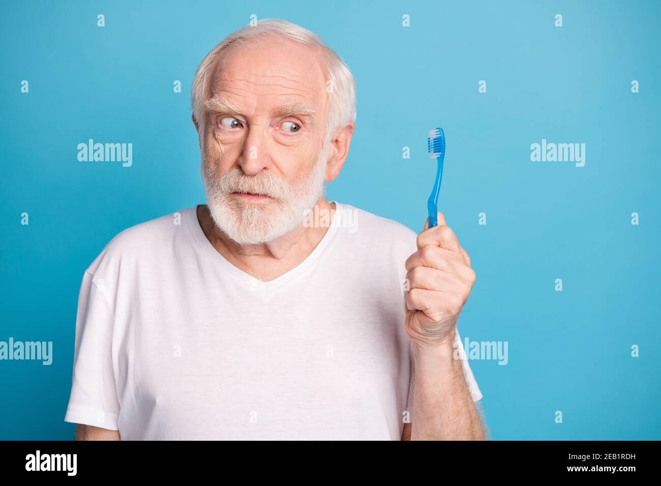 Photo of thoughtful aged person look interested tooth brush isolated on ...
