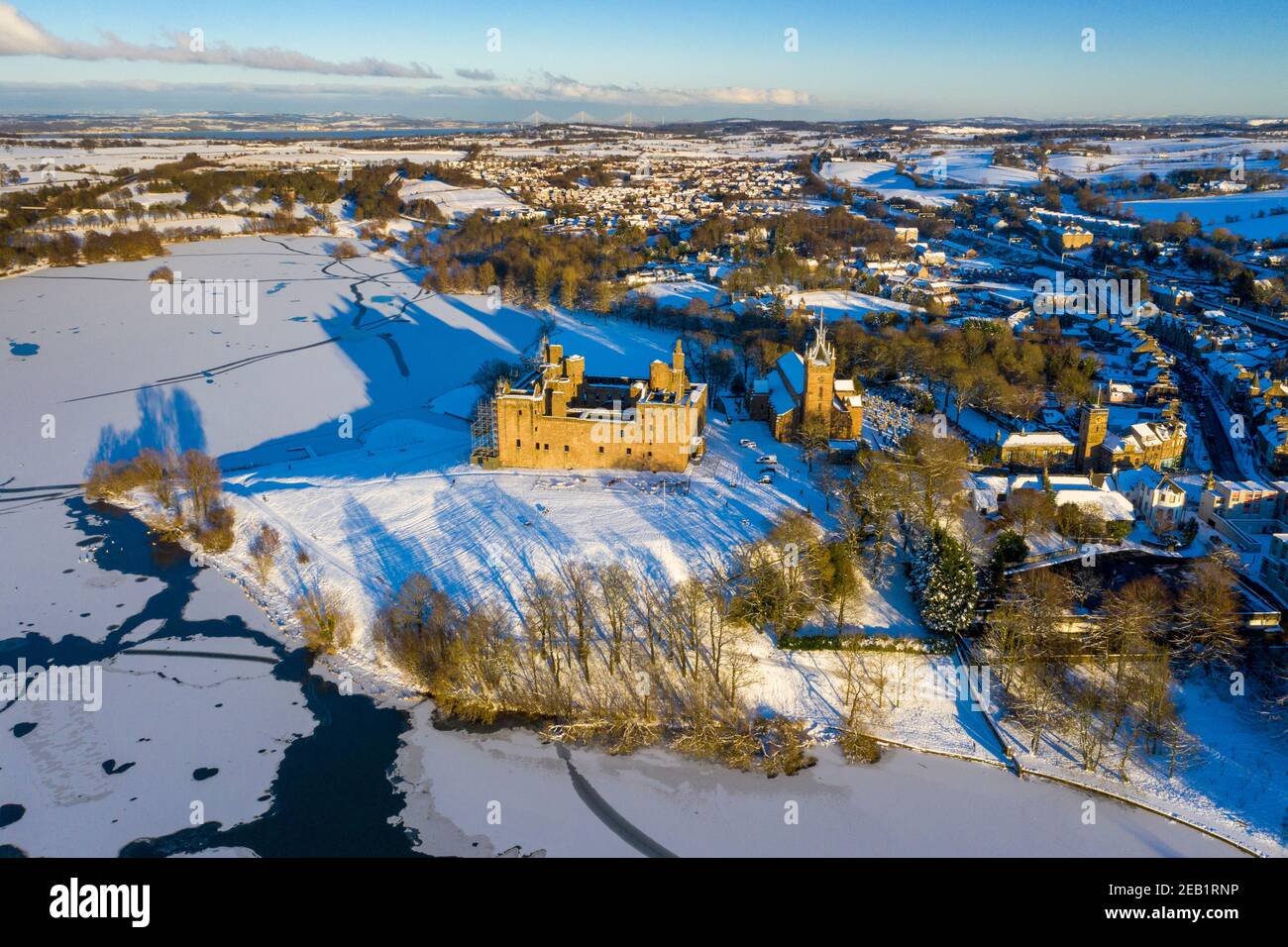 Winter scene Scotland: Aerial view of the sun setting on Linlithgow ...