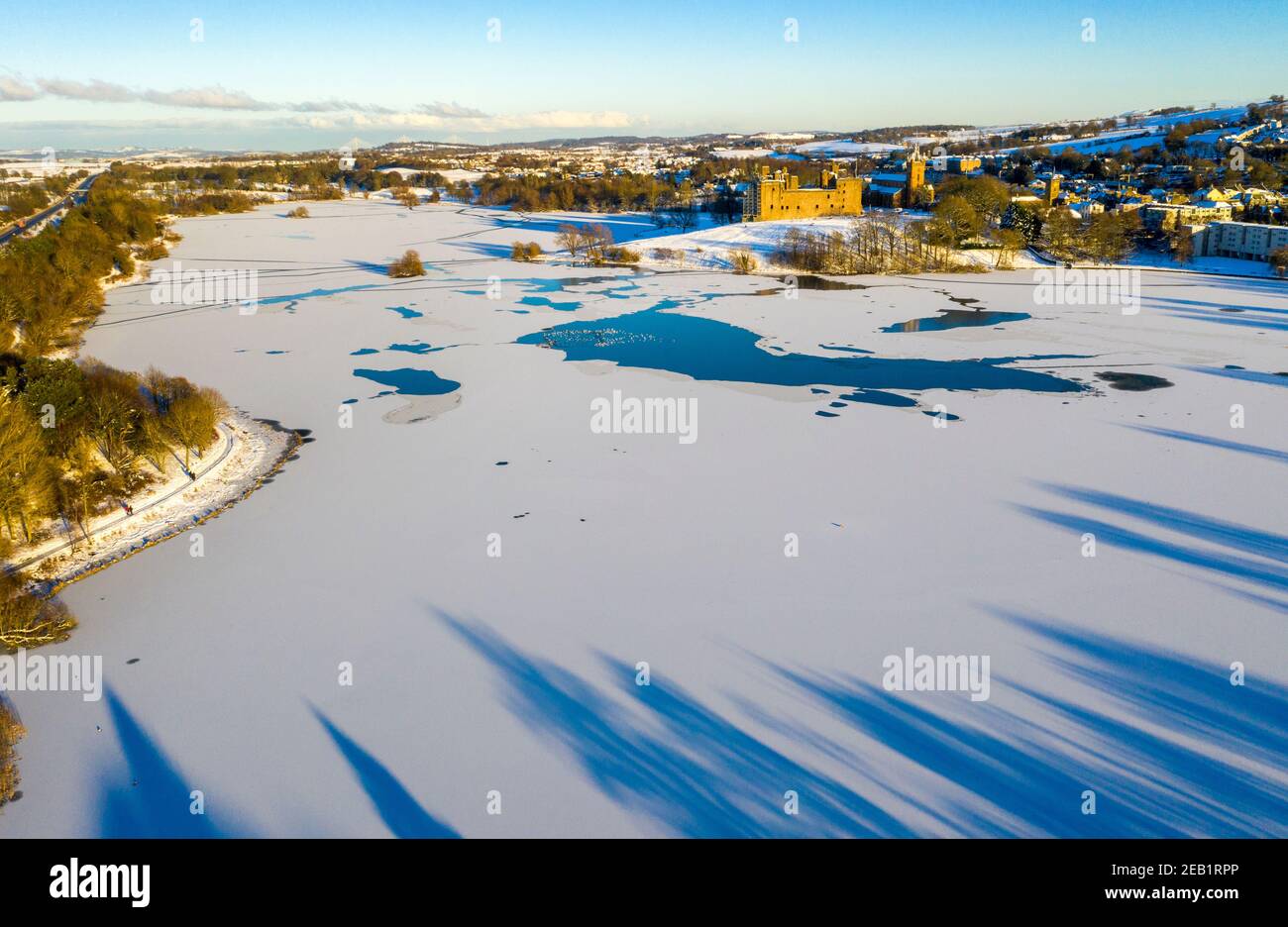 Winter scene Scotland: Aerial view of the sun setting on Linlithgow ...