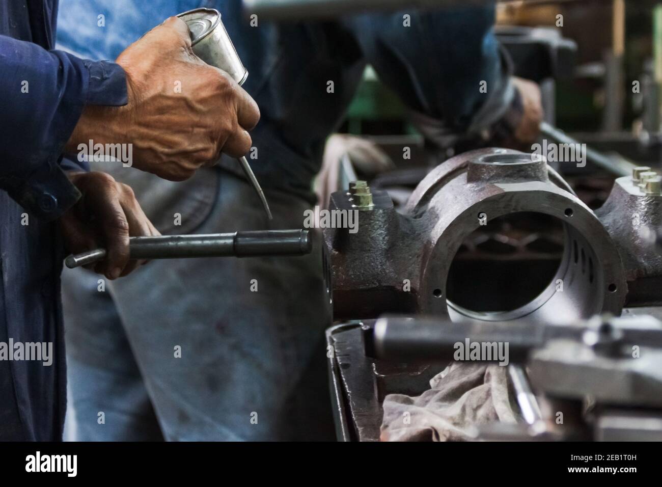 Assembly shop for the production of water pumps.Male hands with veins ...