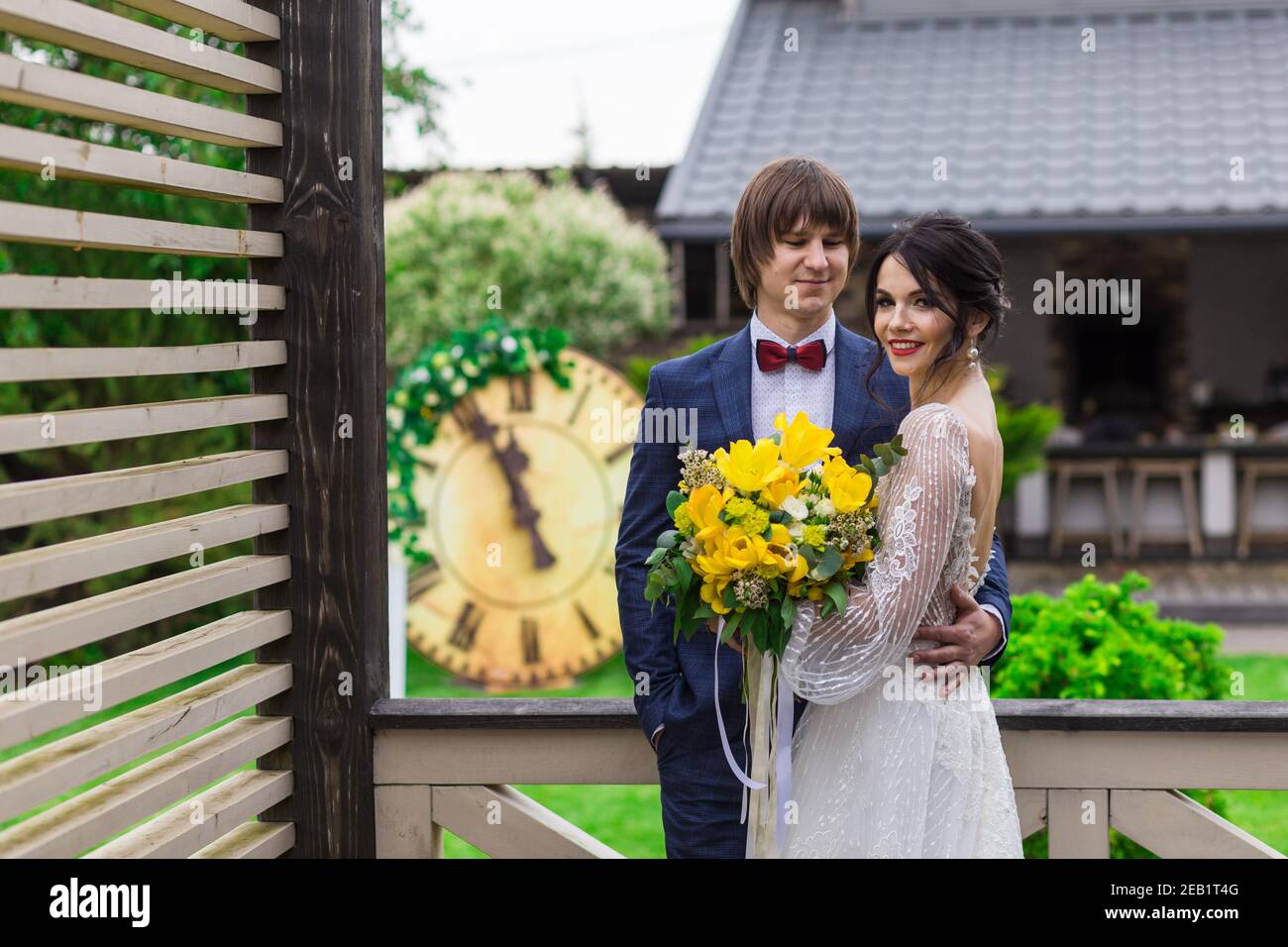 Newly married posing near by luxurious wooden mansion on wedding ...