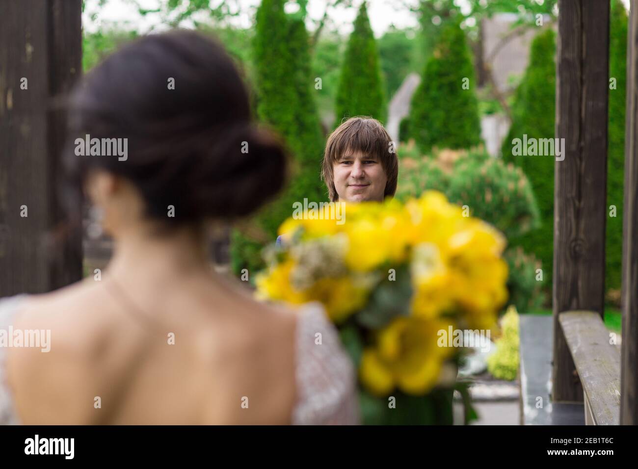 Newly married posing near by luxurious wooden mansion on wedding ...