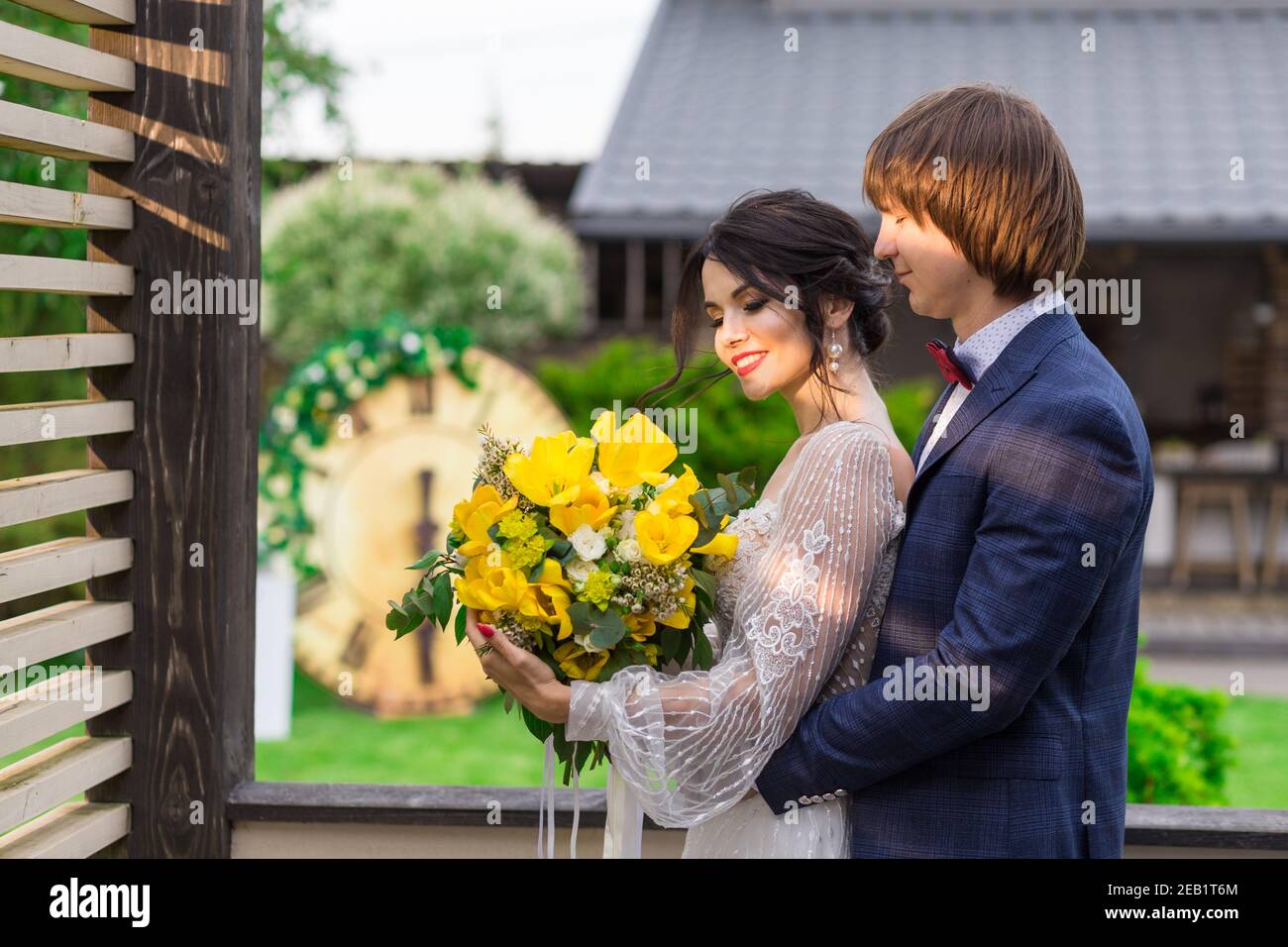 Newly married posing near by luxurious wooden mansion on wedding ...