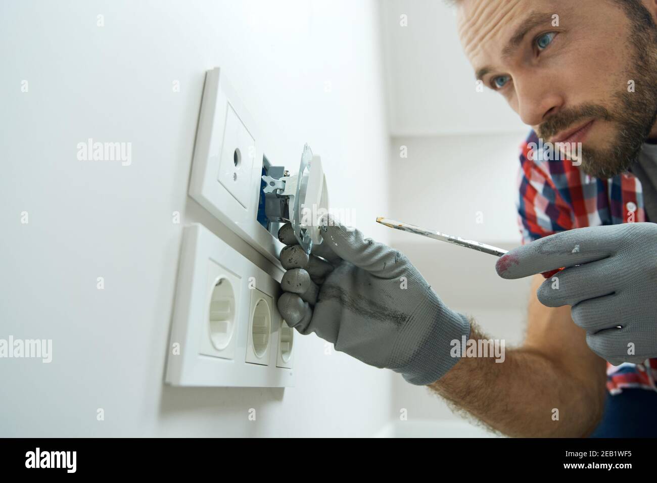 Installation process. Close up shot of electrician wearing protective ...