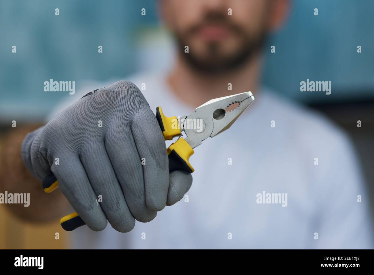 Necessary hand tool. Close up shot of hand of young repairman holding ...