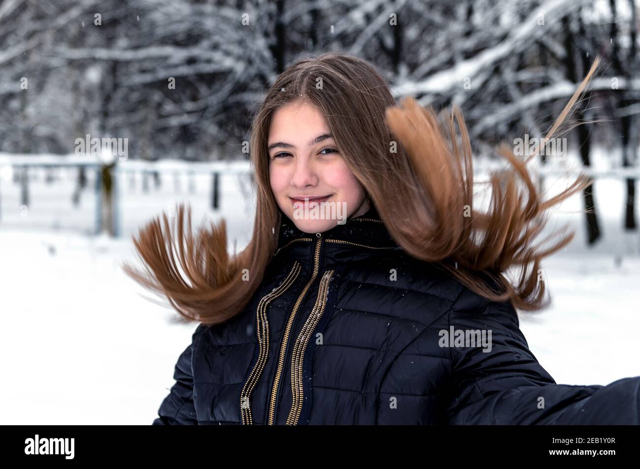 Beautiful girl on winter snow background. Spectacular long-haired girl ...