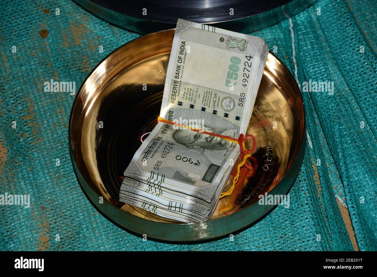 Pile of Indian rupee banknotes in a golden bowl Stock Photo - Alamy