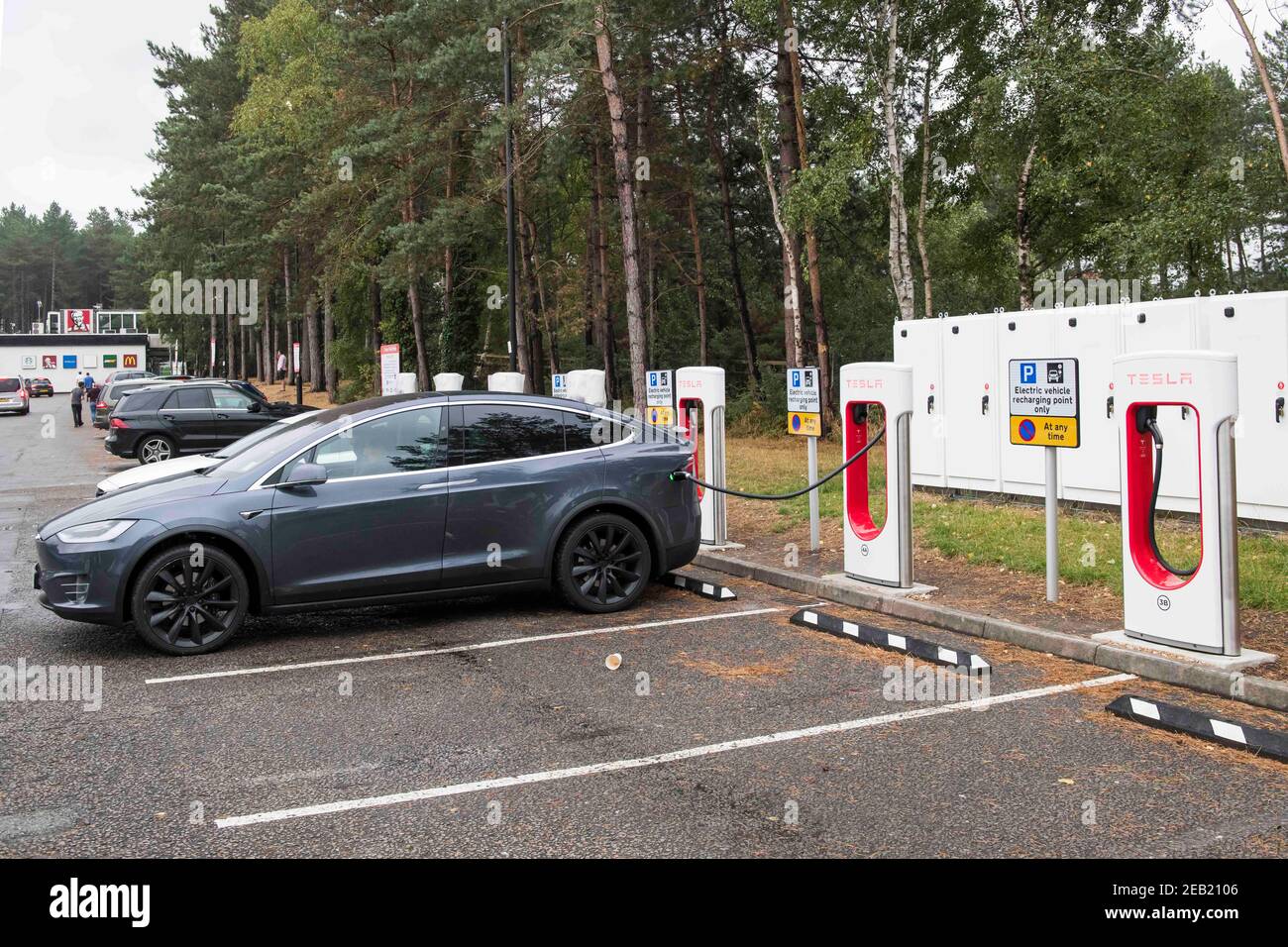 A Tesla Electric car is charged at a Tesla charging point at a service ...