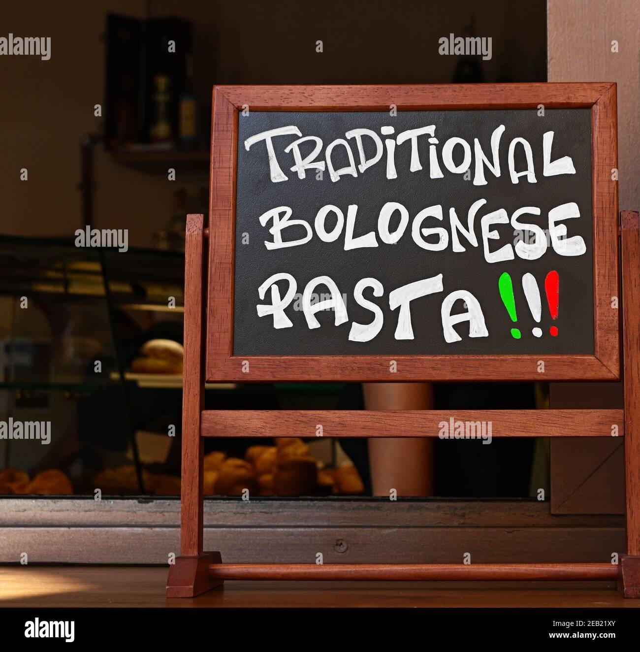 Blackboard with written text "Traditional Bolognese Pasta" in front of ...
