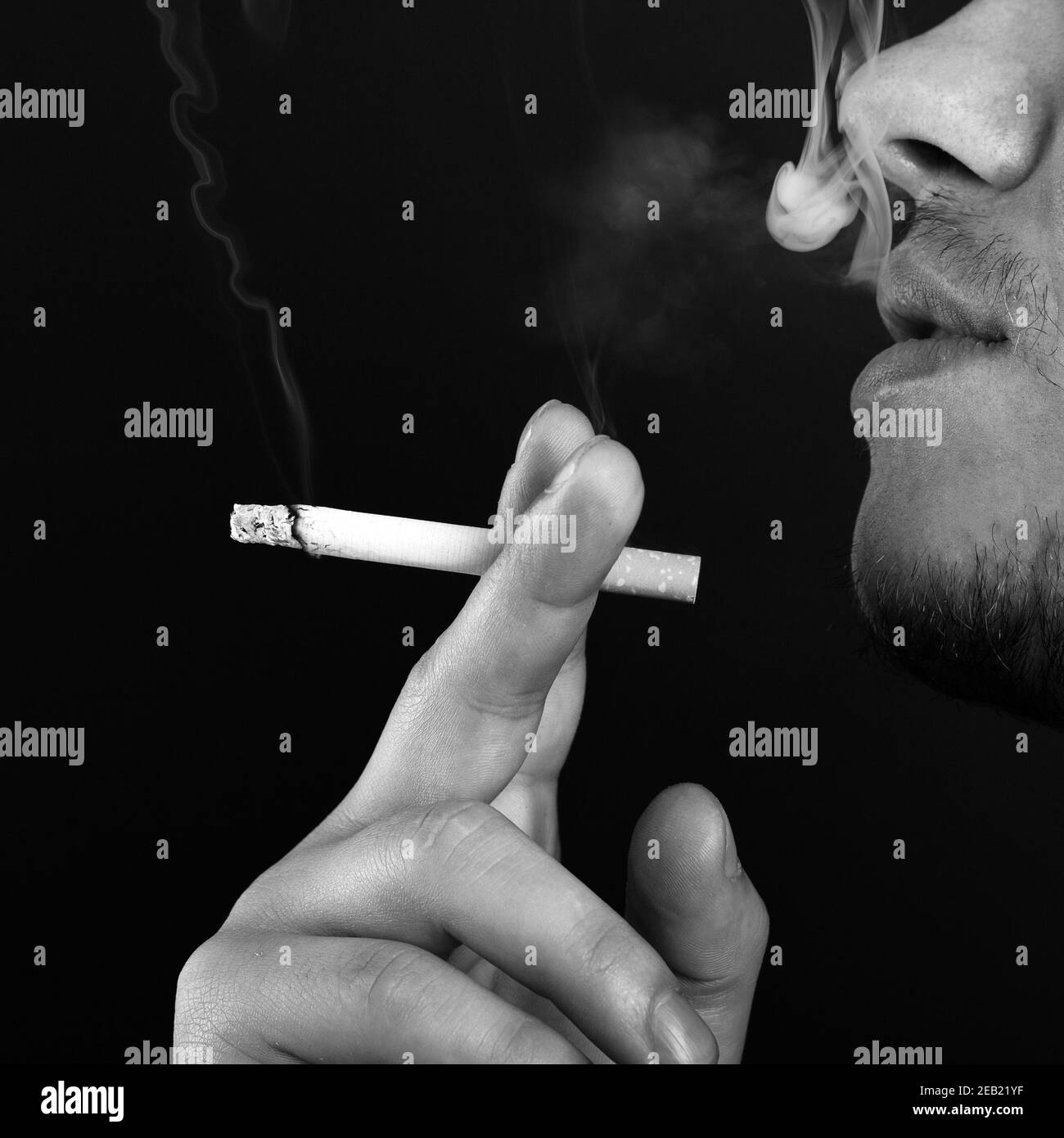 Cigarette in hand Black and White Stock Photos & Images - Alamy