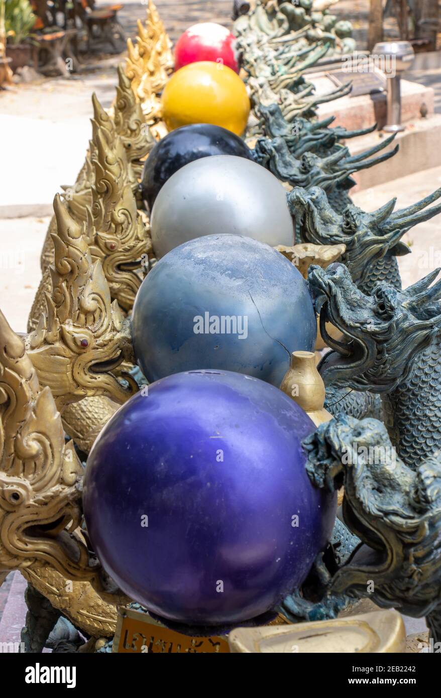 Naga and dragon together hold ball in her open mouth, Buddhist temple ...