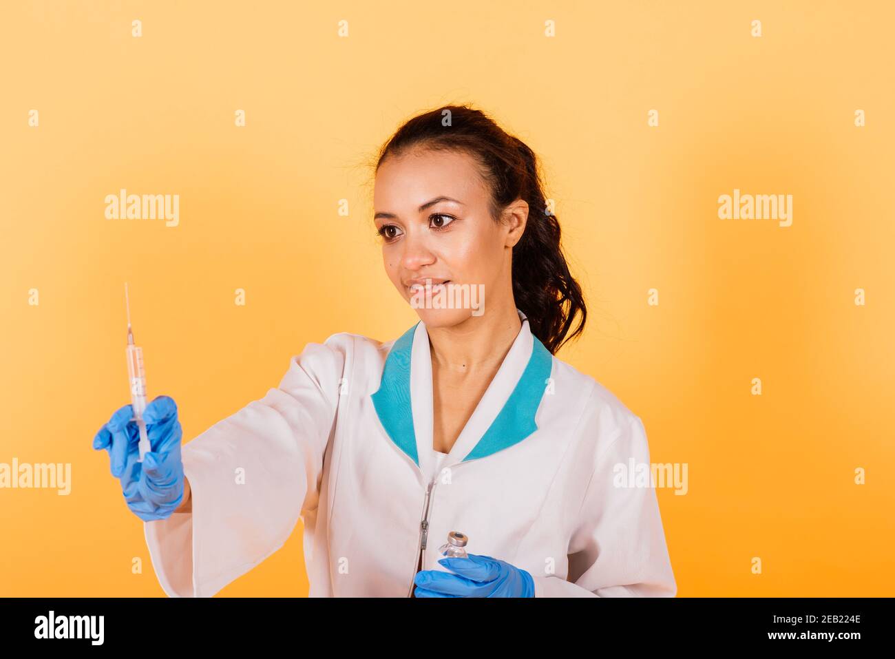 Female medical professional scientist researcher holding a syringe ...