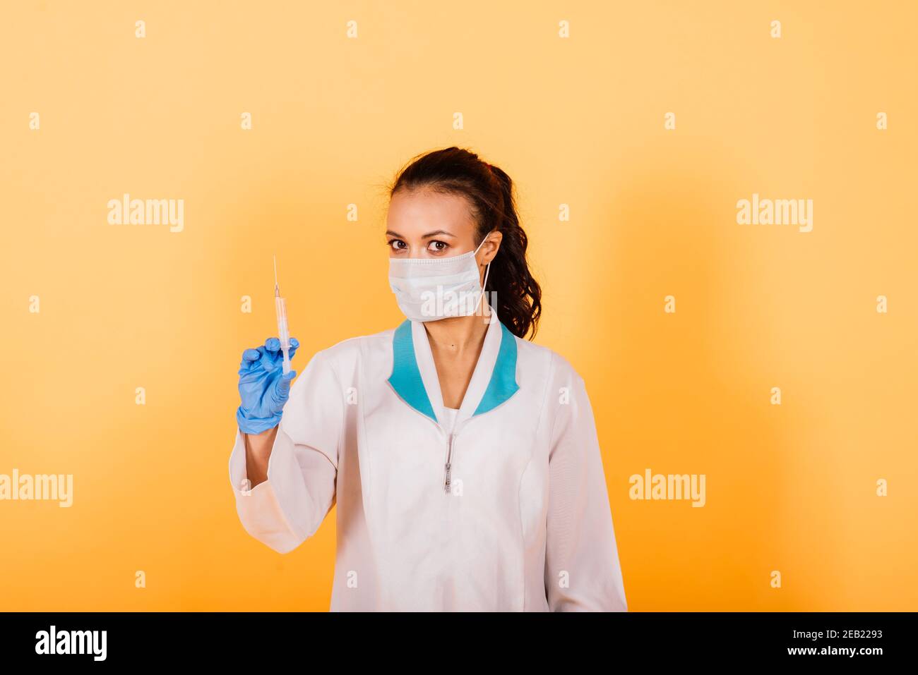 Female medical professional scientist researcher holding a syringe ...