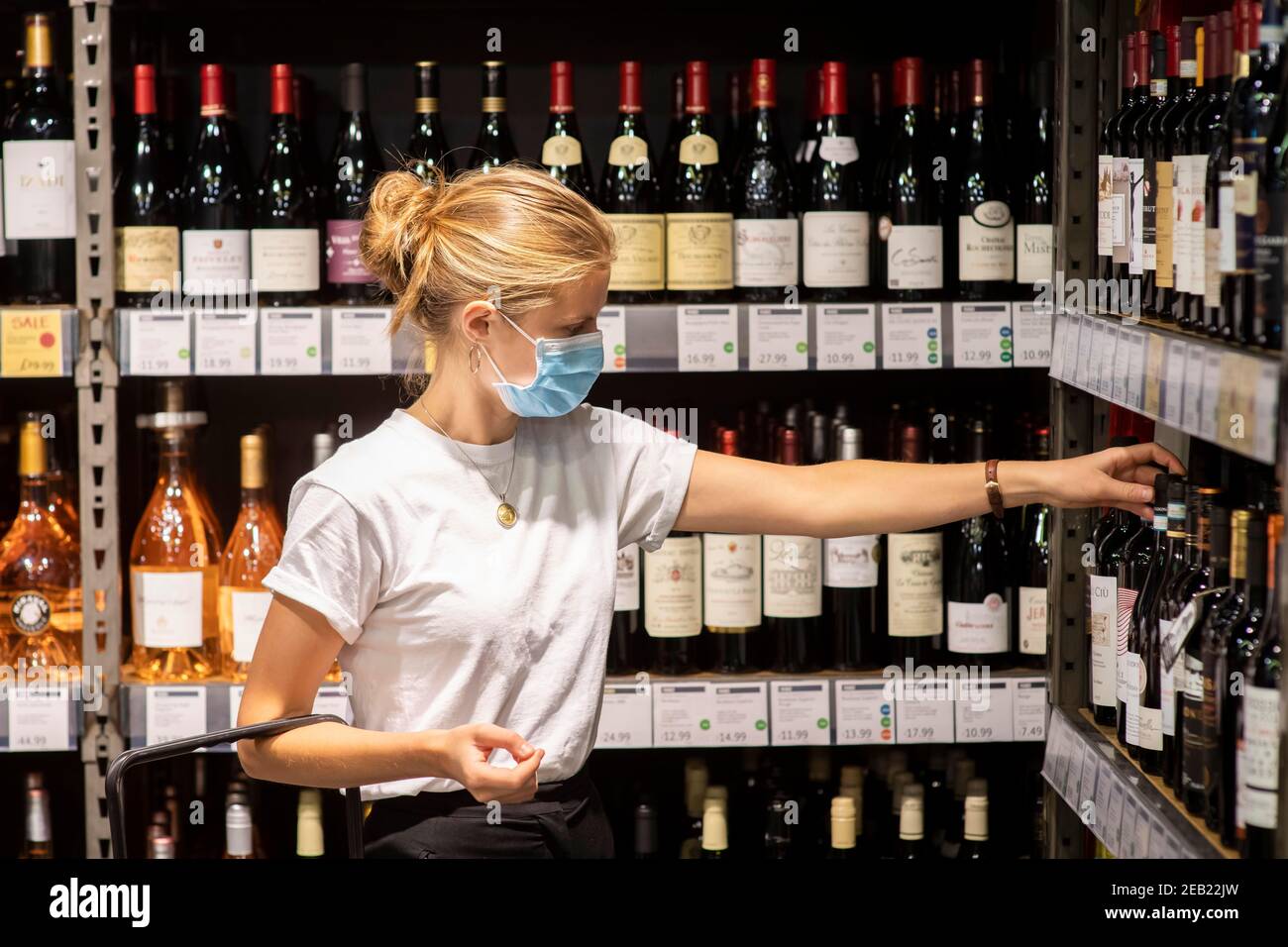 A woman shops wearing a face covering, as face masks become compulsory ...
