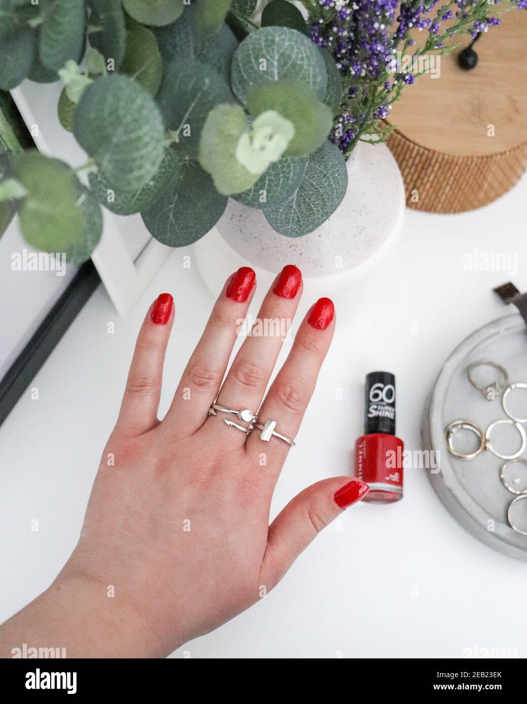 Red painted nails hand wearing rings hi-res stock photography and ...